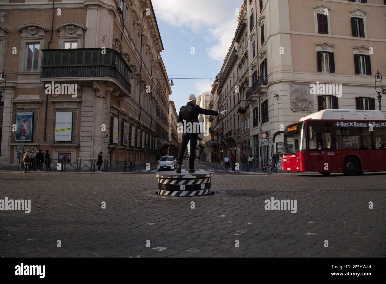 Rome, Italy. 26th Mar, 2021. A traffic policeman directs traffic from ...