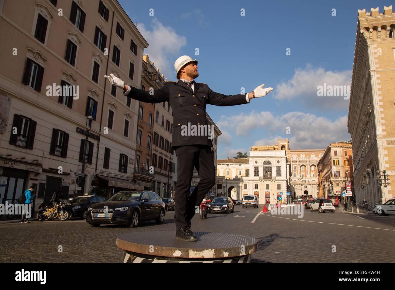 Rome, Italy. 26th Mar, 2021. A traffic policeman directs traffic from ...