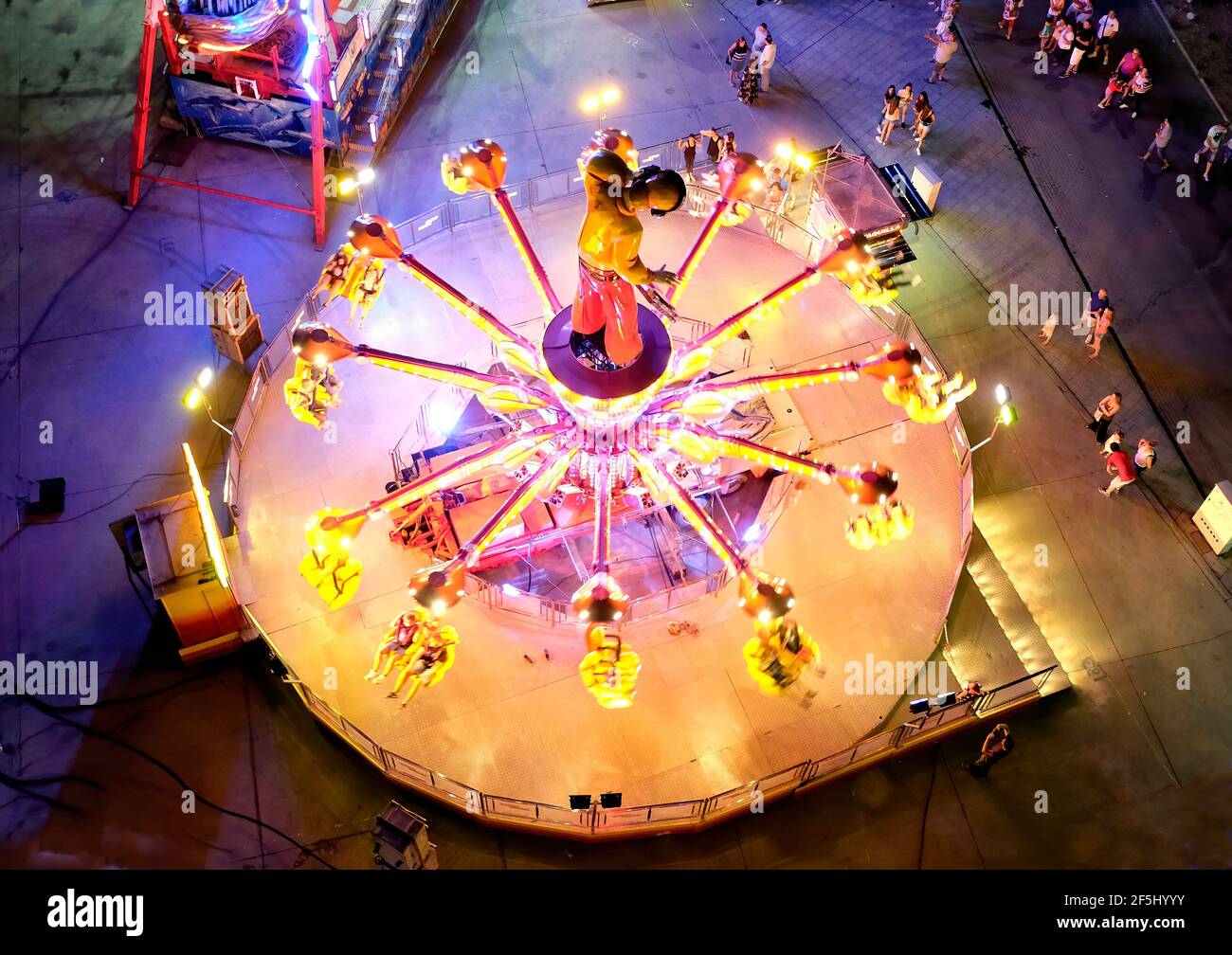 moving fairground attraction seen from above with people around it ...