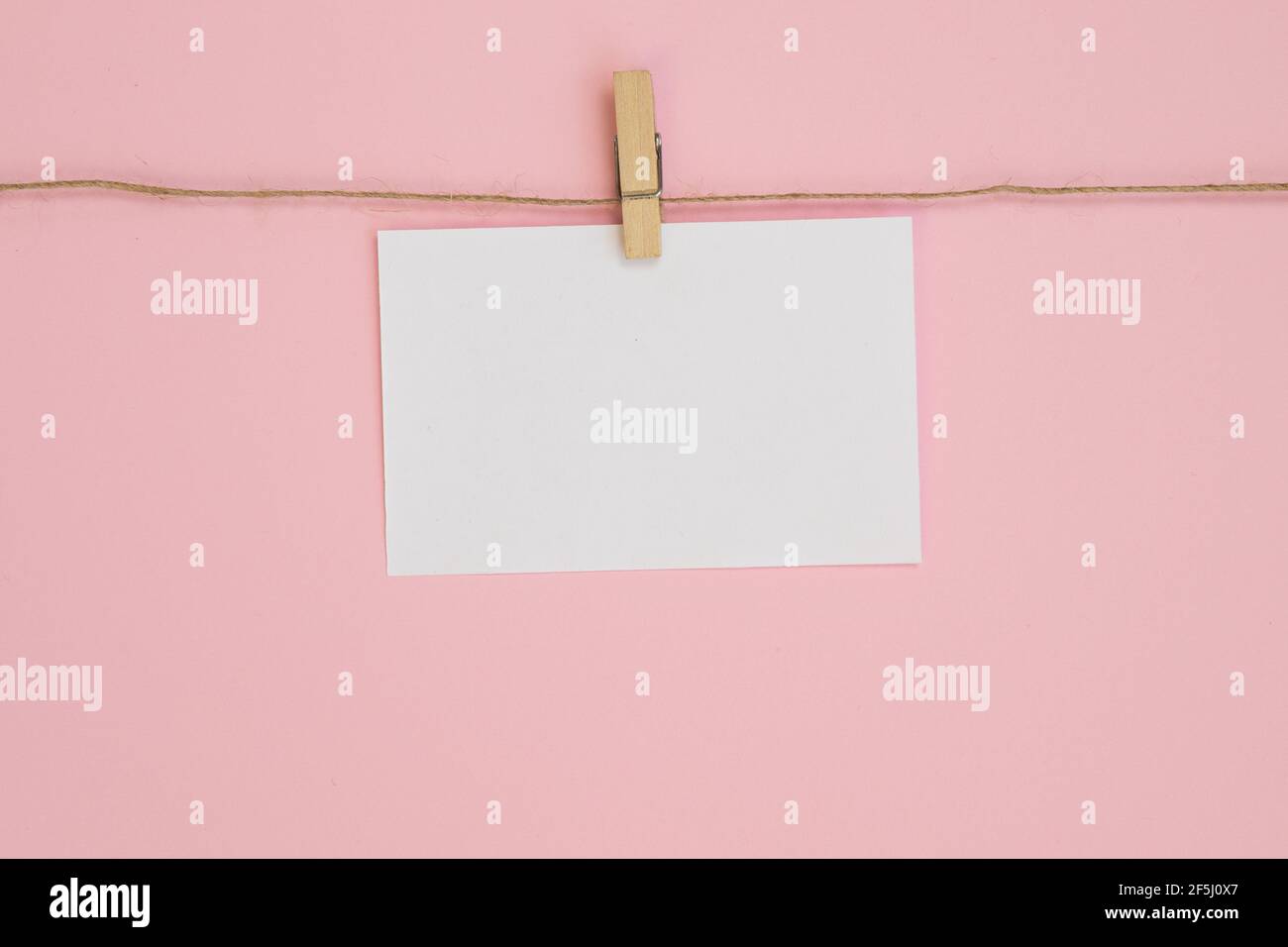 Empty paper sheet for notes, frames that hang on a rope with clothespin ...