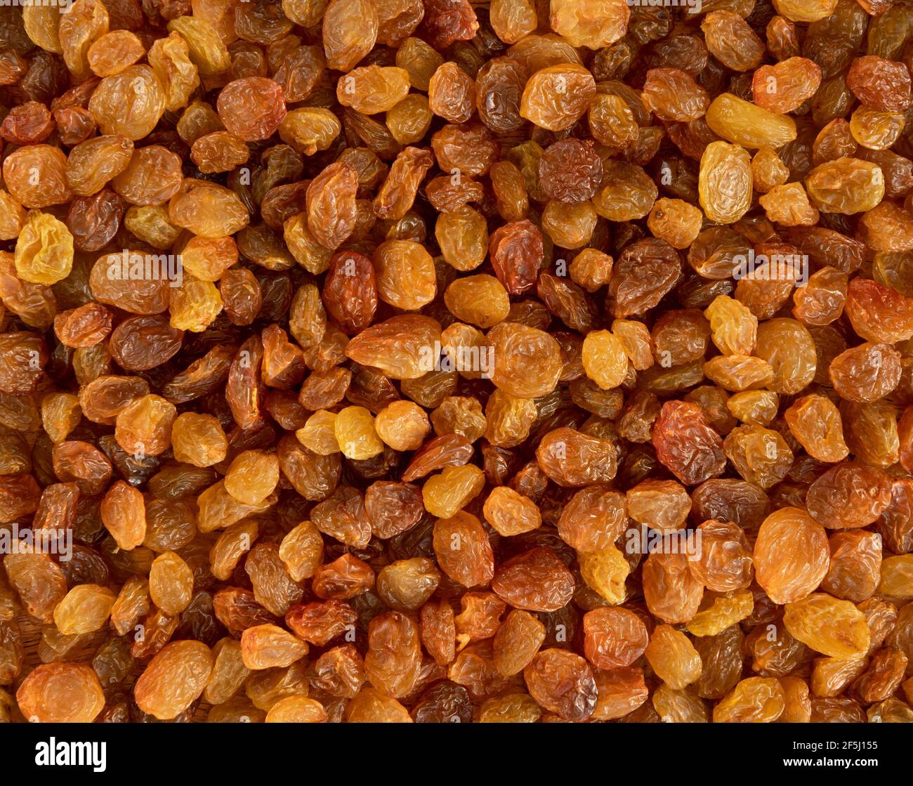 Dry organic yellow and orange raisins or dried grapes. Food texture ...