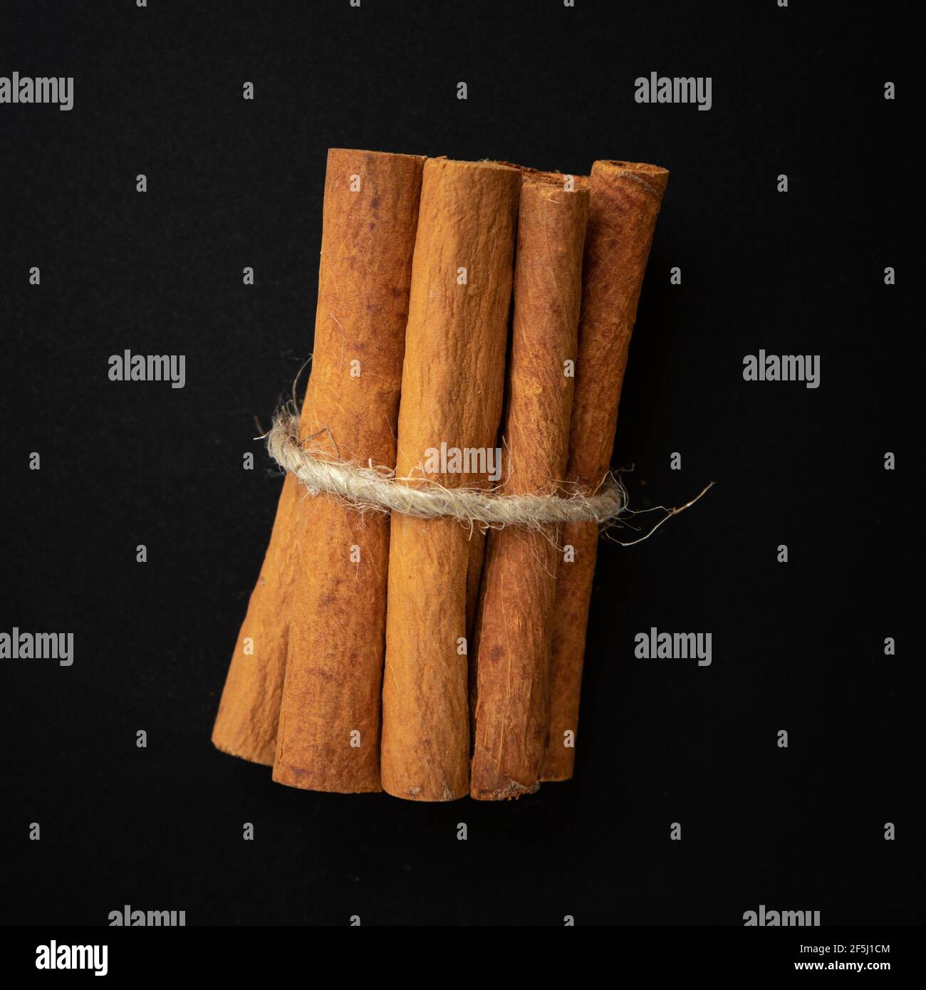 Cinnamon sticks bunch isolated on dark background, selective focus ...
