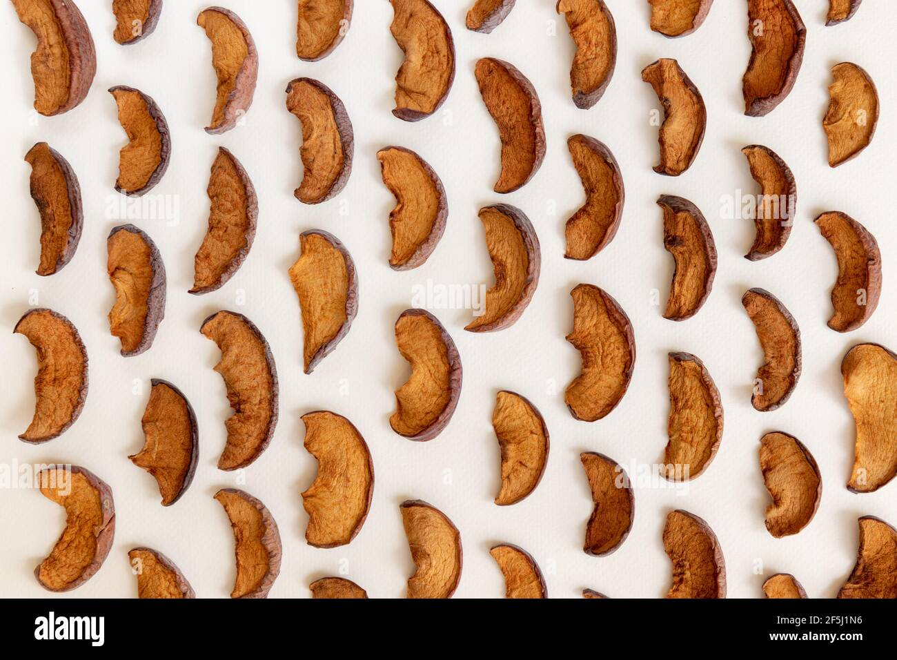 Slices of sun dried fruits dehydrated apples on white background ...