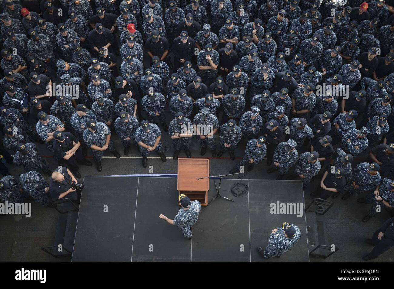 Rear Adm. speaks to the crew of USS Iwo Jima during an all hands call ...