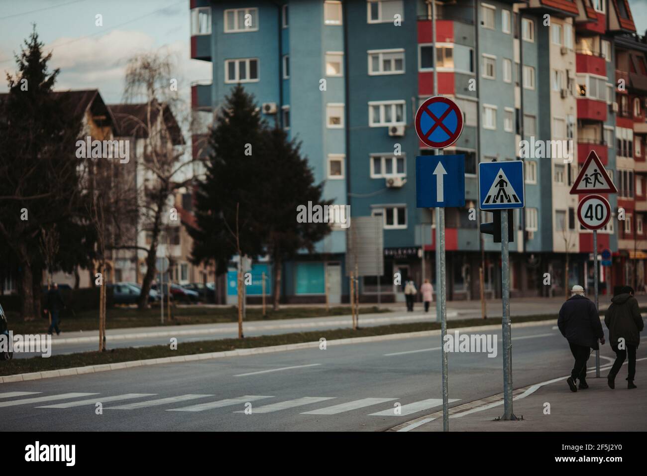 Urban street with pedestrian road signs by the crosswalk Stock Photo ...