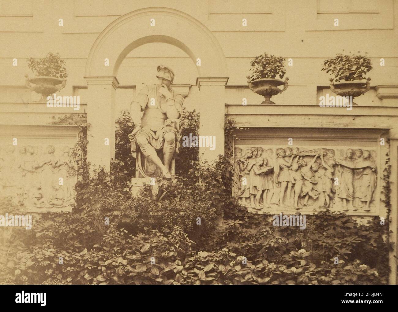 Marble sculpture of a seated man within an arch with bas-reliefs in ...