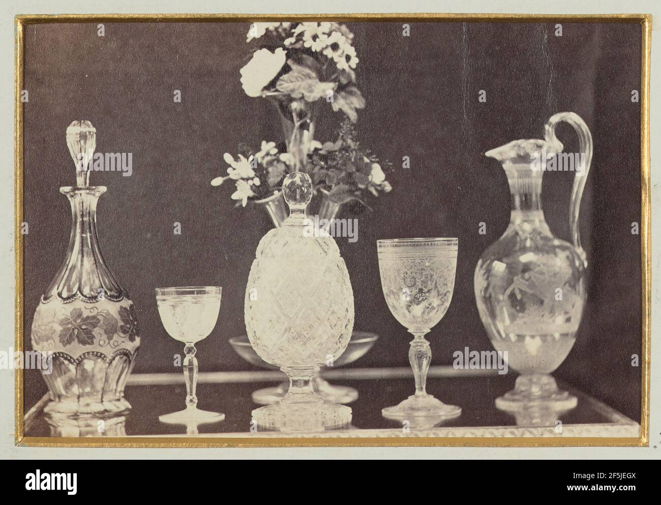 Ornate water pitcher, two goblets, two decanters with flower ...