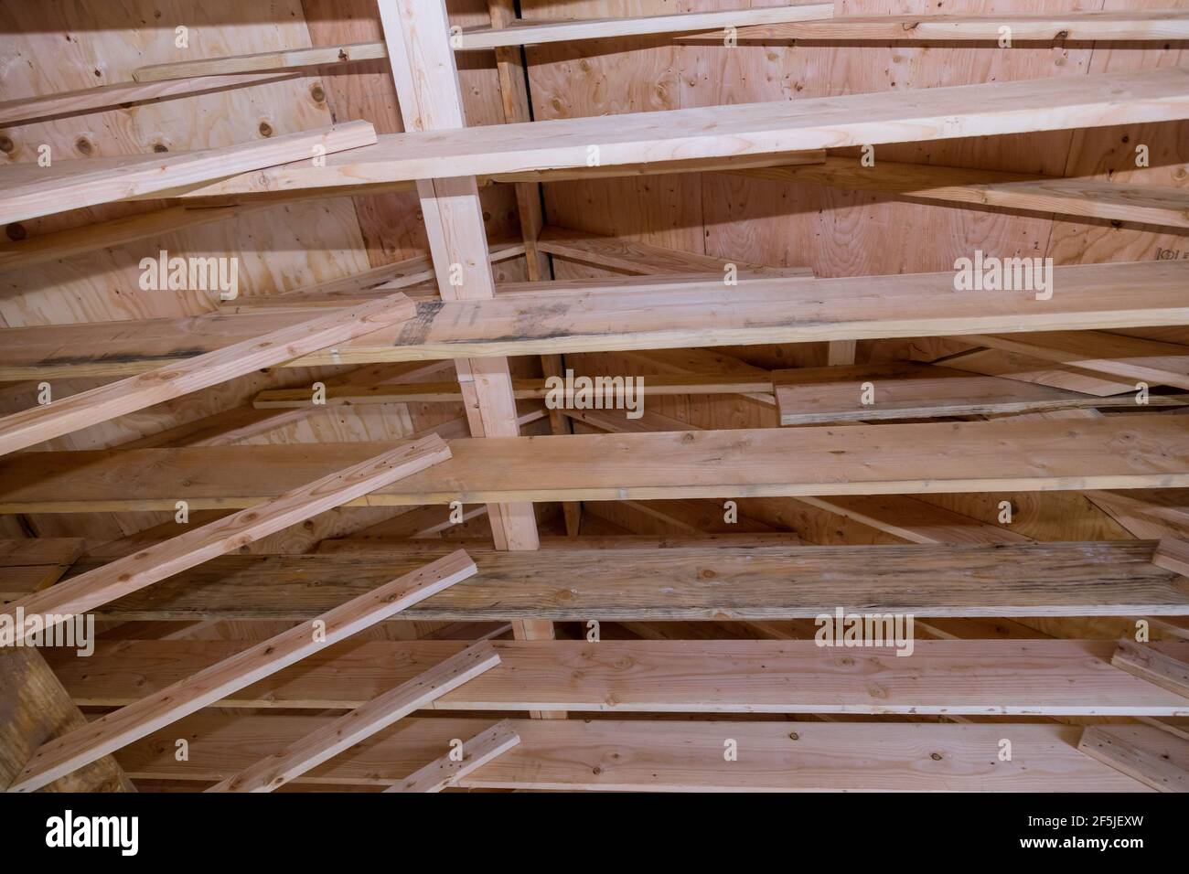 Residential attic under with wooden frame under construction beams ...