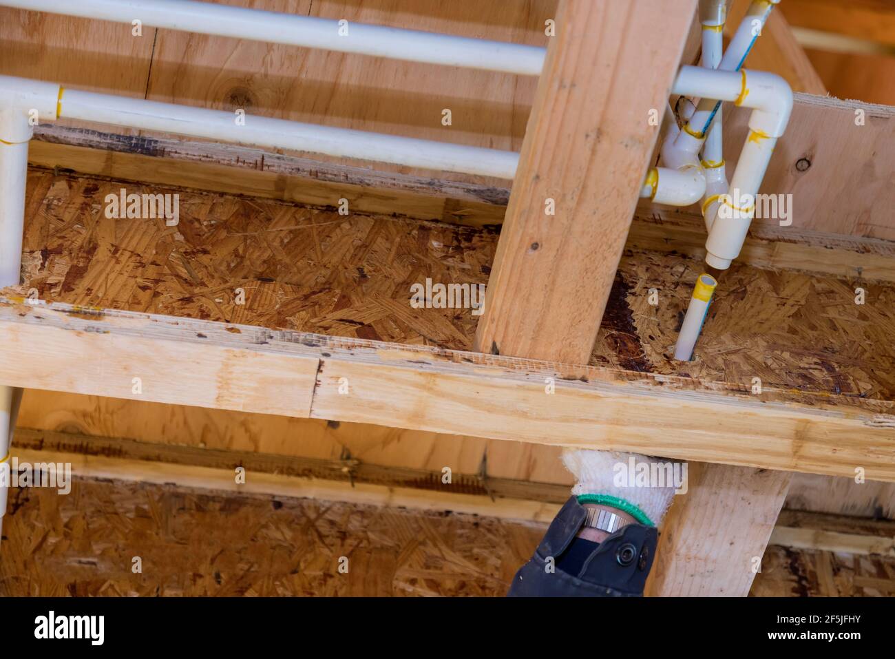 Plumber gluing cement CPVC plastic water line white pipe on of new ...