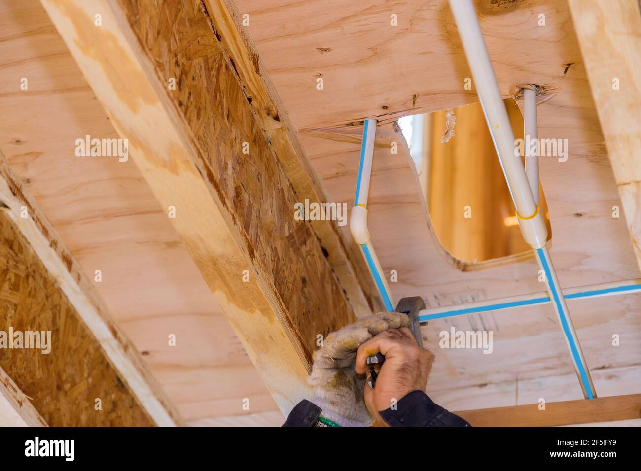Maintenance plumber man hand using pvc pipe cutter for cut the water ...
