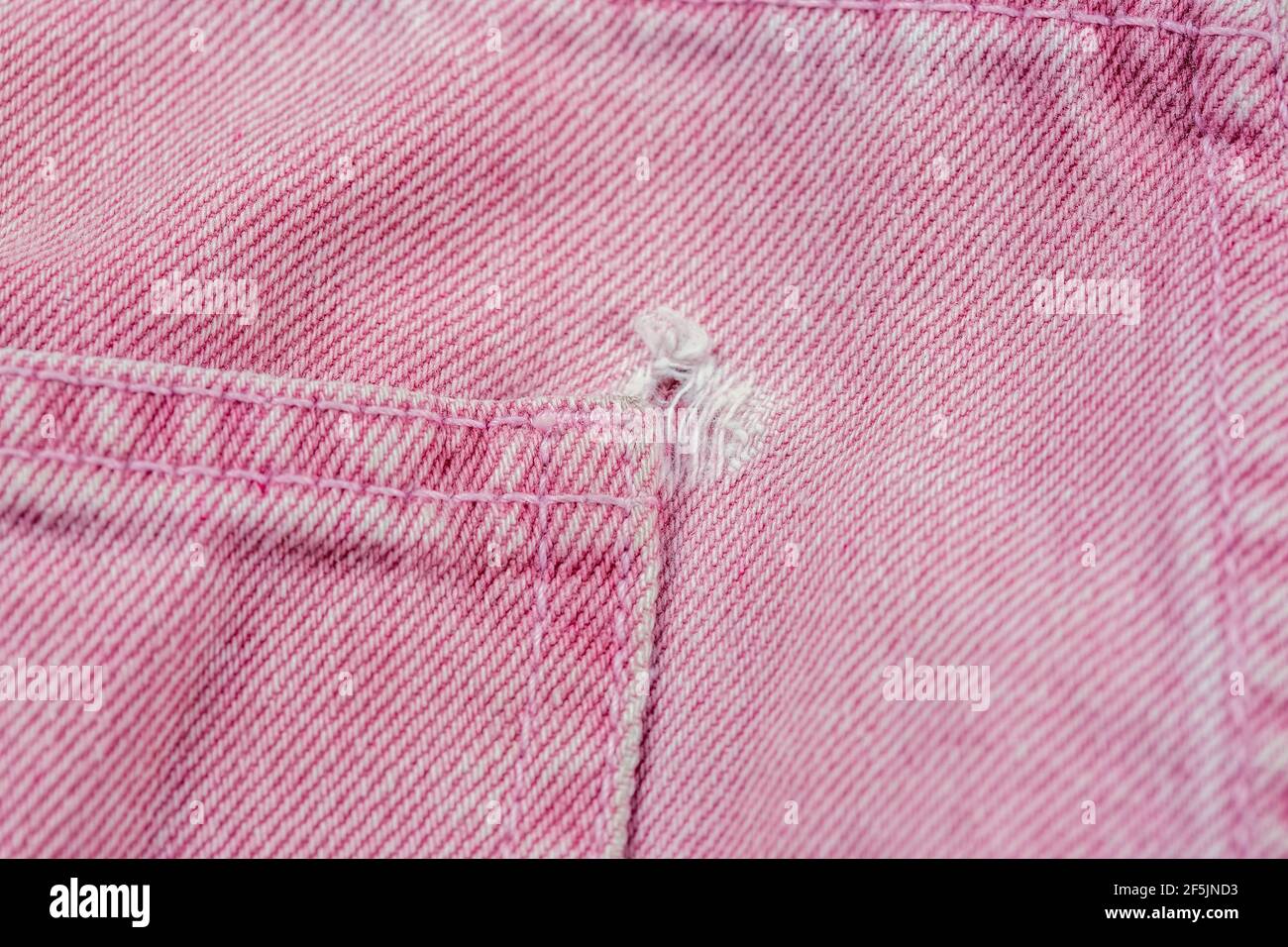 A close-up of a frayed pink jeans pocket, a torn off pocket Stock Photo ...