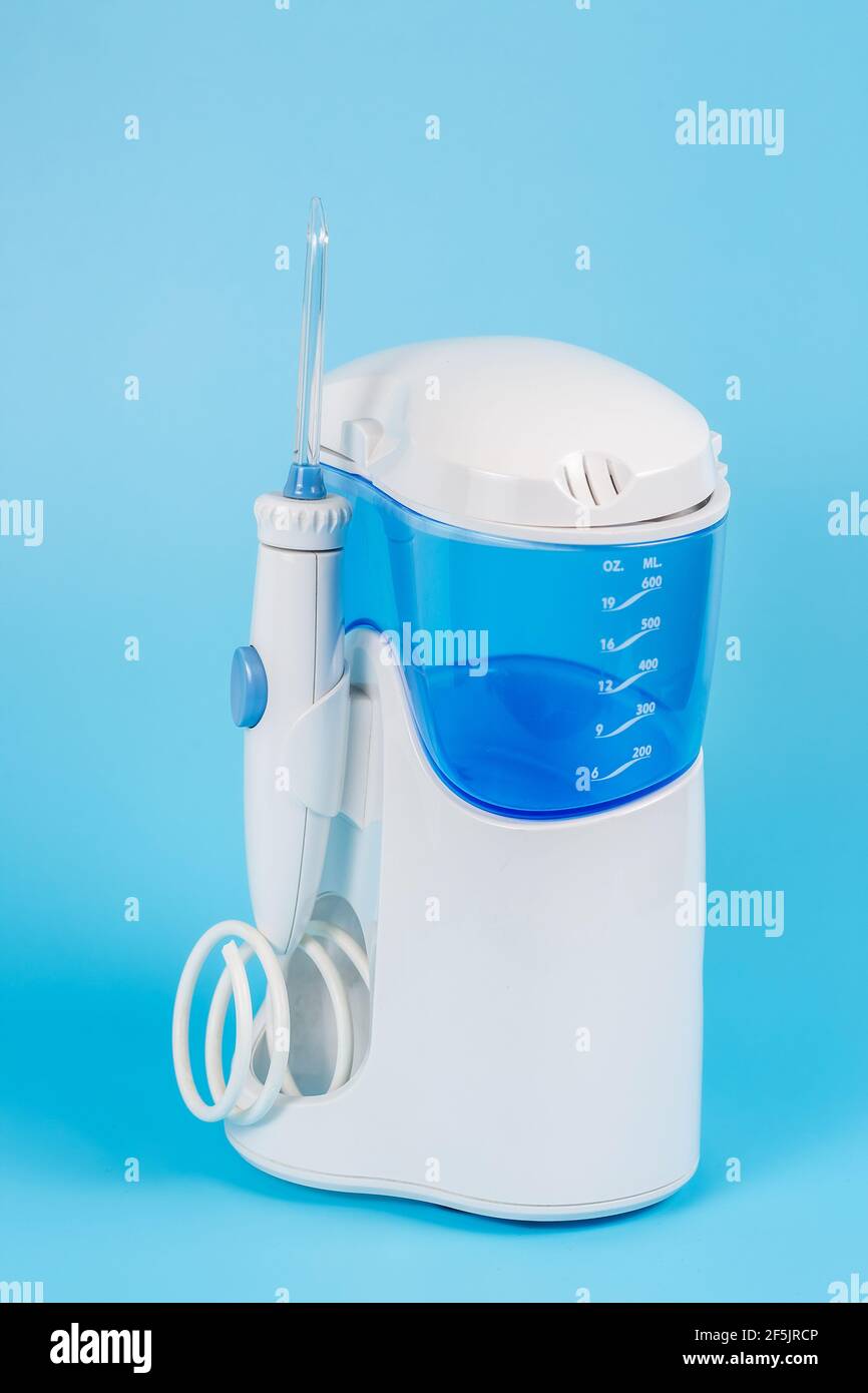 Electronic Tooth Irrigator for personal home usage on blue background ...