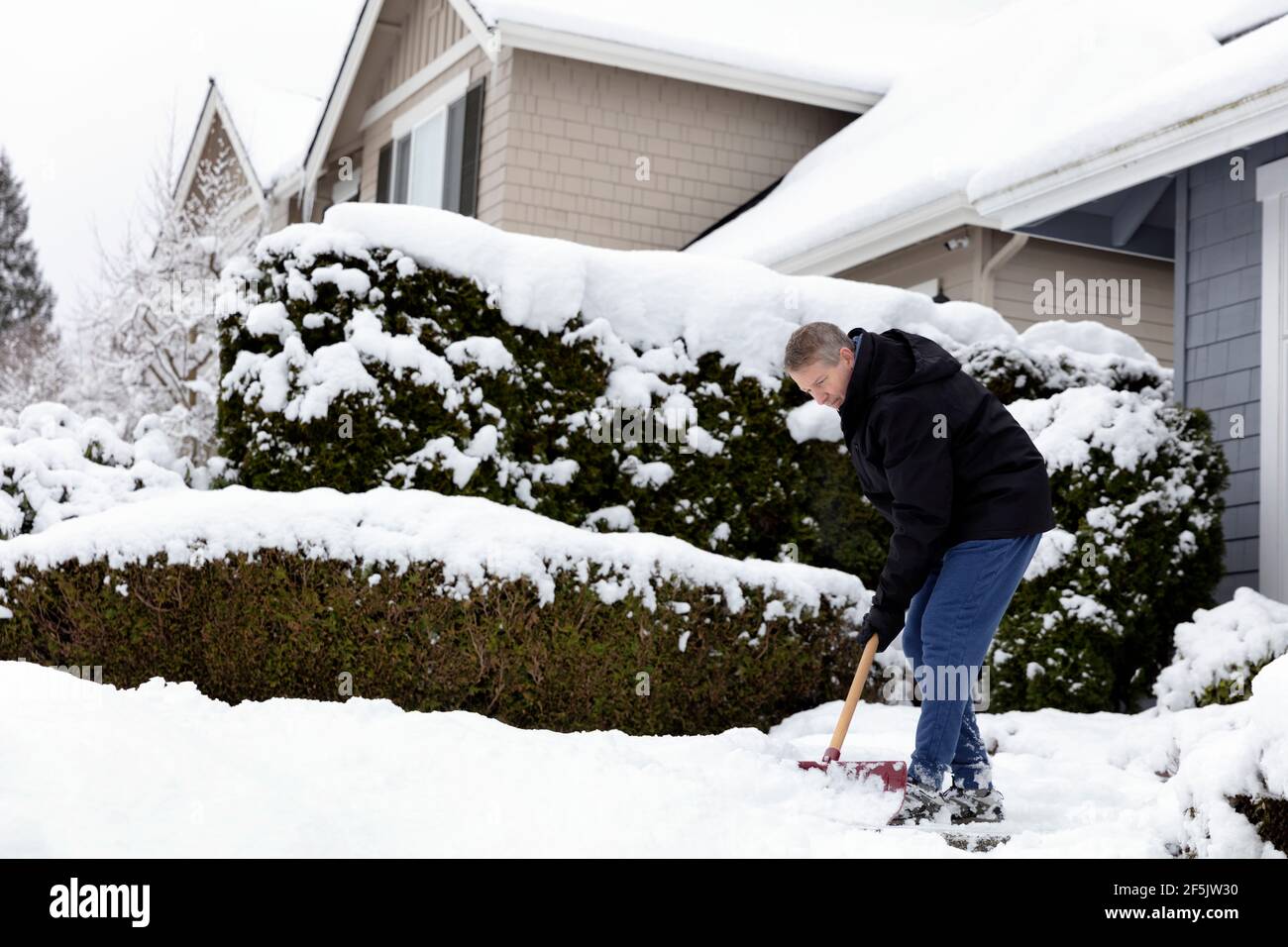 Man shoveling snow hi-res stock photography and images - Alamy