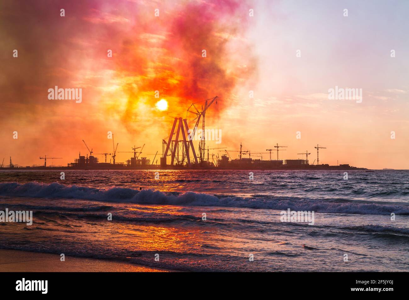 Construction site in Dubai at the sea sunset Stock Photo - Alamy