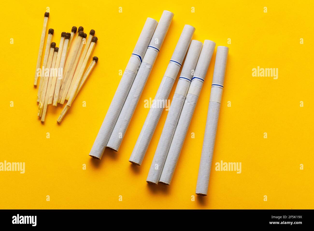 Cigarettes and Matches at Yellow Background Stock Photo - Alamy