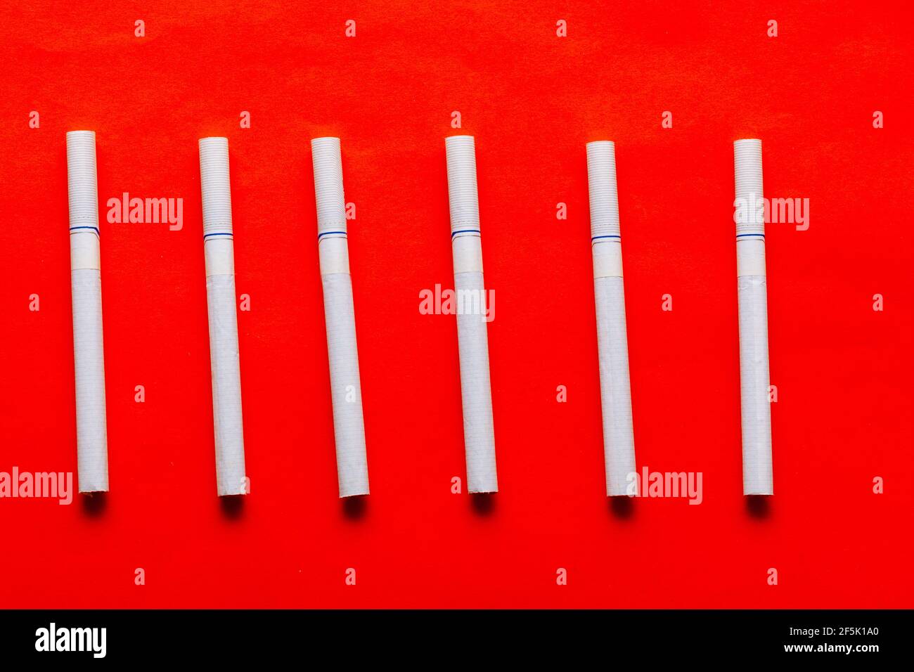 White cigarettes at red background . Nicotine in Tobacco Stock Photo ...