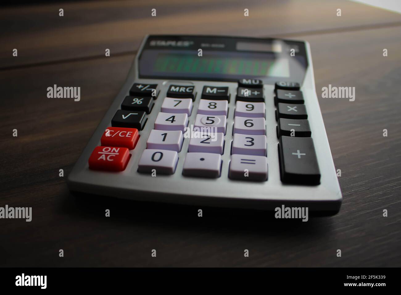 Calculator keypad on a wooden floor background. Top view. Copy space ...