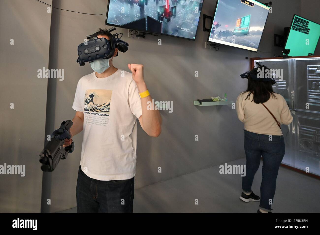 New York, USA. 26th Mar, 2021. Two people compete in a virtual laser ...