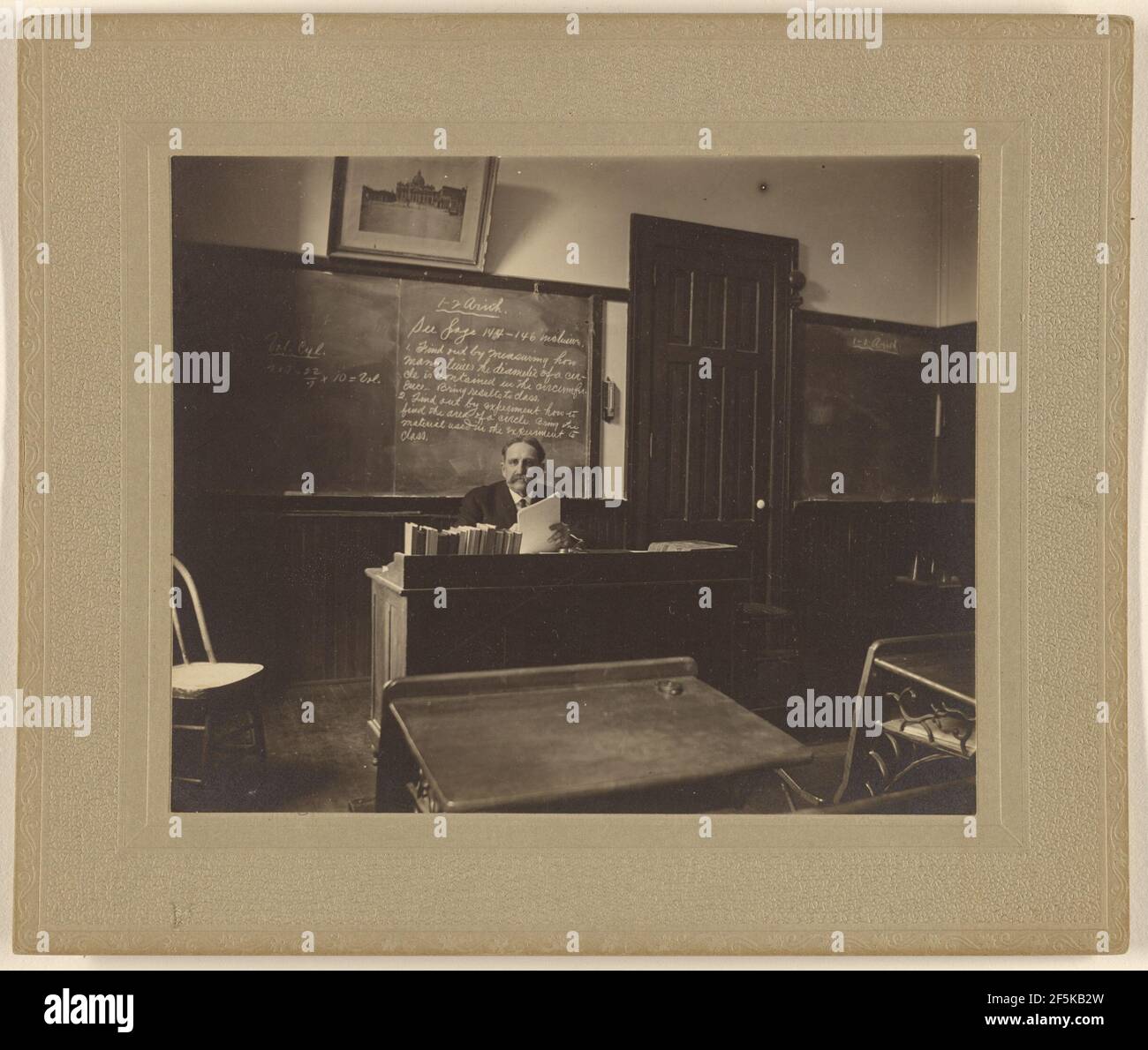 Portrait of a male mathematics teacher with moustache seated at his ...