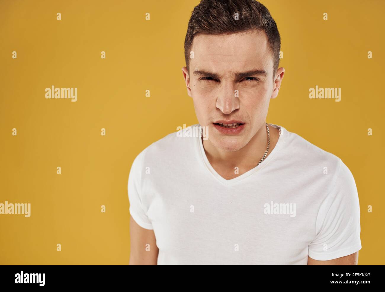 Angry man on a yellow background cry of emotion and stress Stock Photo ...