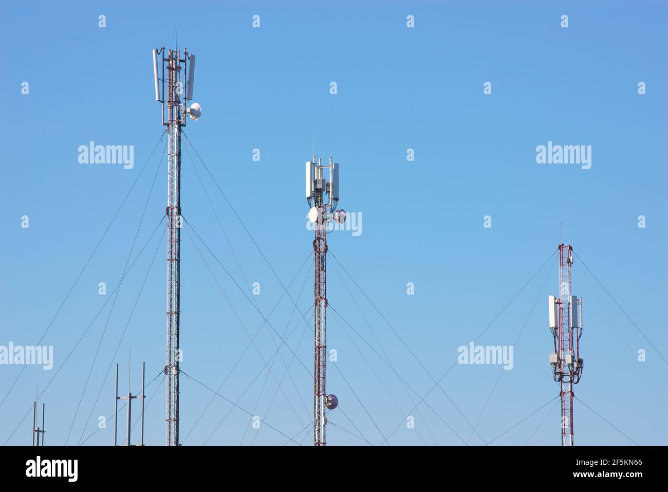 Telecommunication radio antenna towers. Technology construction on sky ...