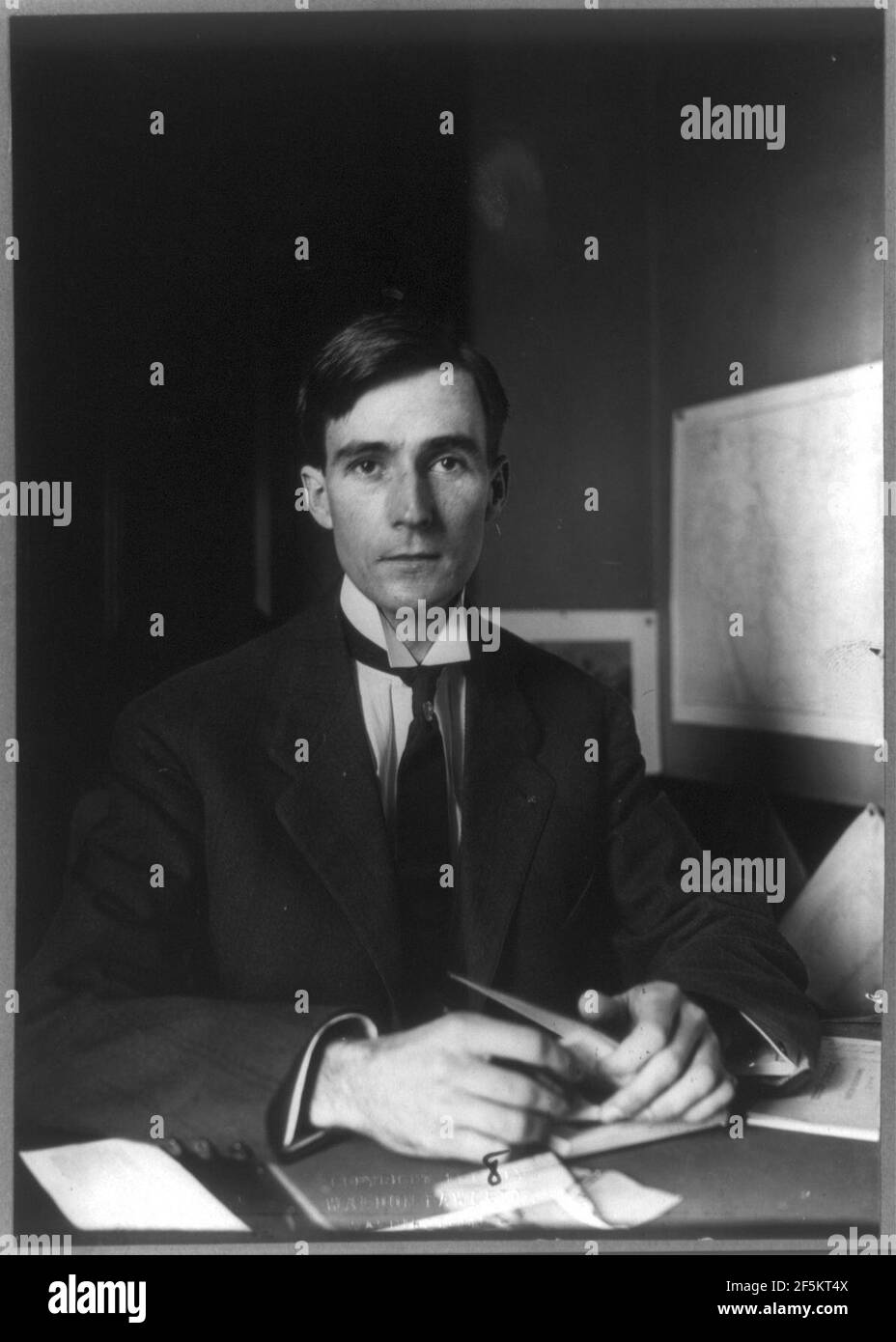 Raymond W. Pullman, half-length portrait, seated behind desk, facing ...