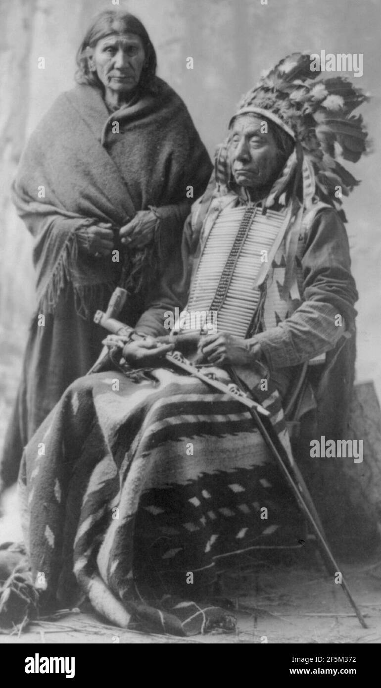 Red Cloud & wife. (seated, in regalia, holding pipe Stock Photo - Alamy