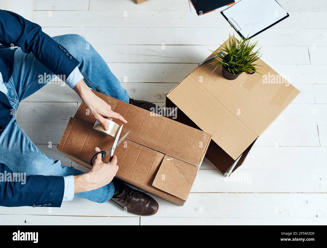 Man packing boxes moving office professional official Stock Photo - Alamy