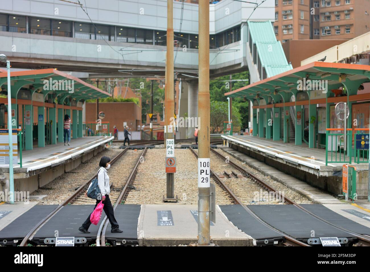 Light rail platforms and at-grade pedestrian crossing at Siu Hong ...