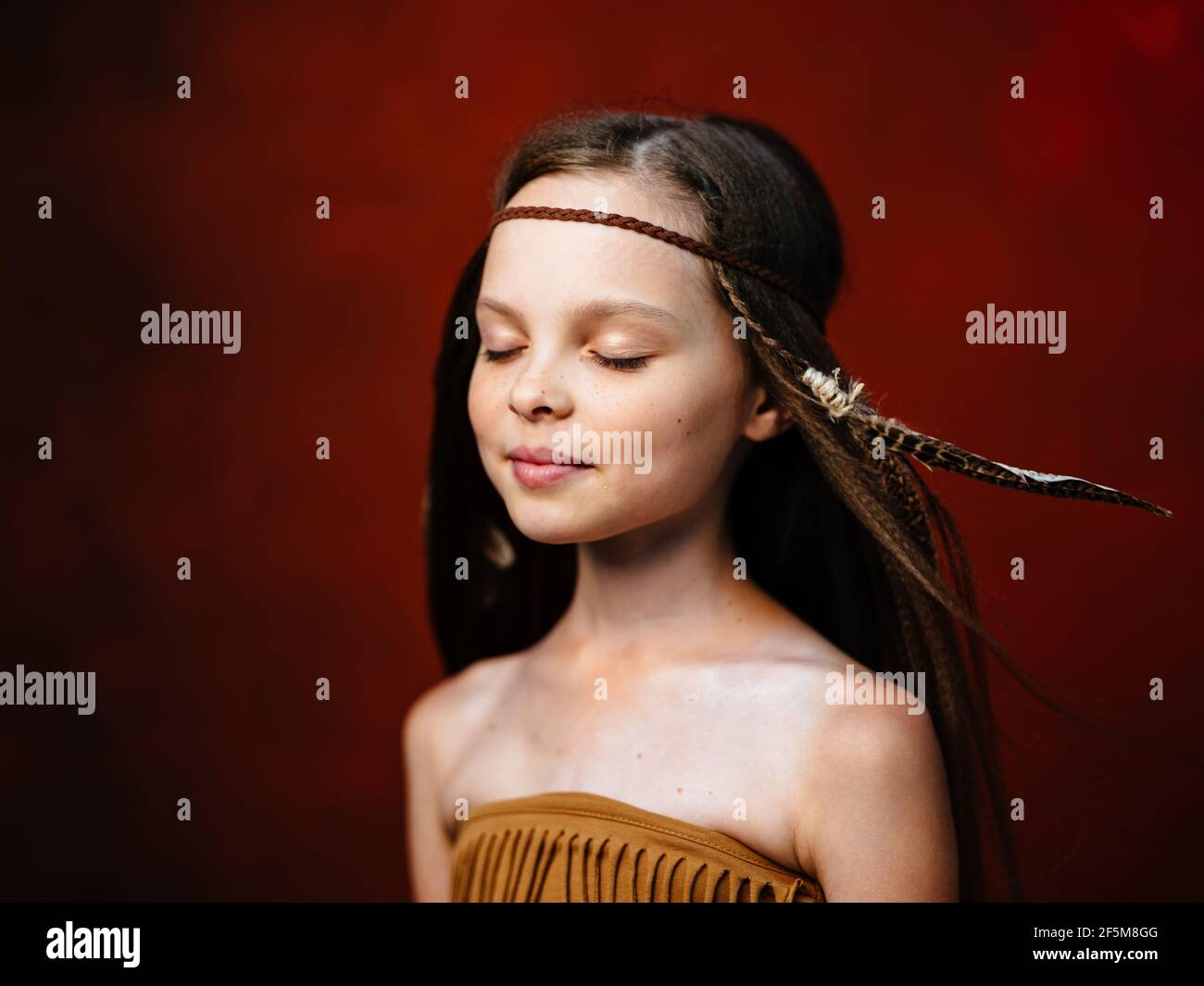 Happy girl with a feather in her hair aborigines indian tribe Shaman ...