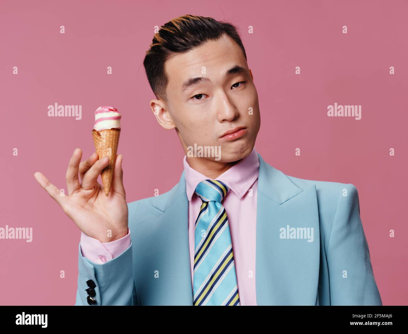 Cute man in blue suit ice cream in hands self confidence fun pink ...