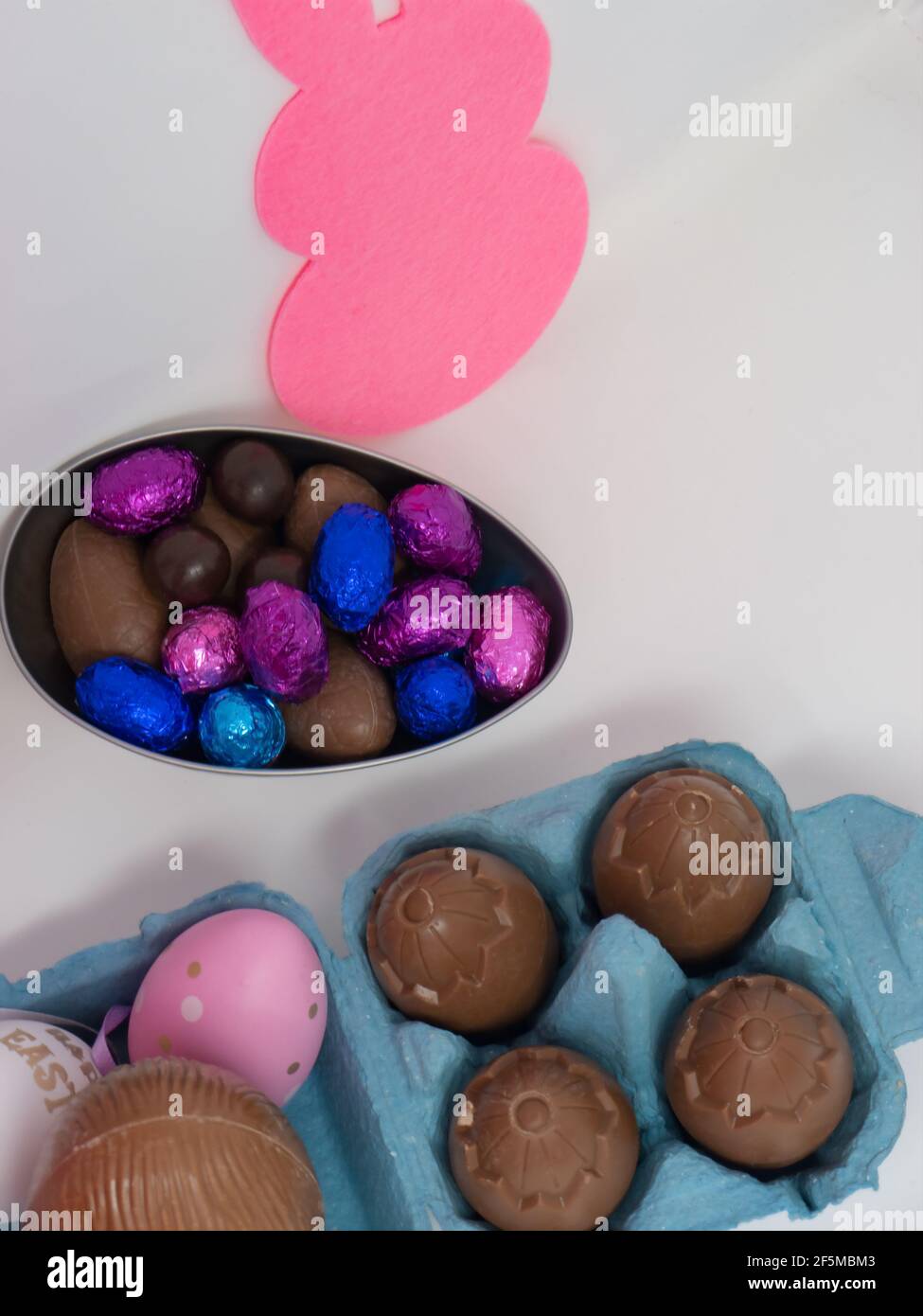 Chocolate Easter eggs in an egg carton and in an egg-shaped container ...