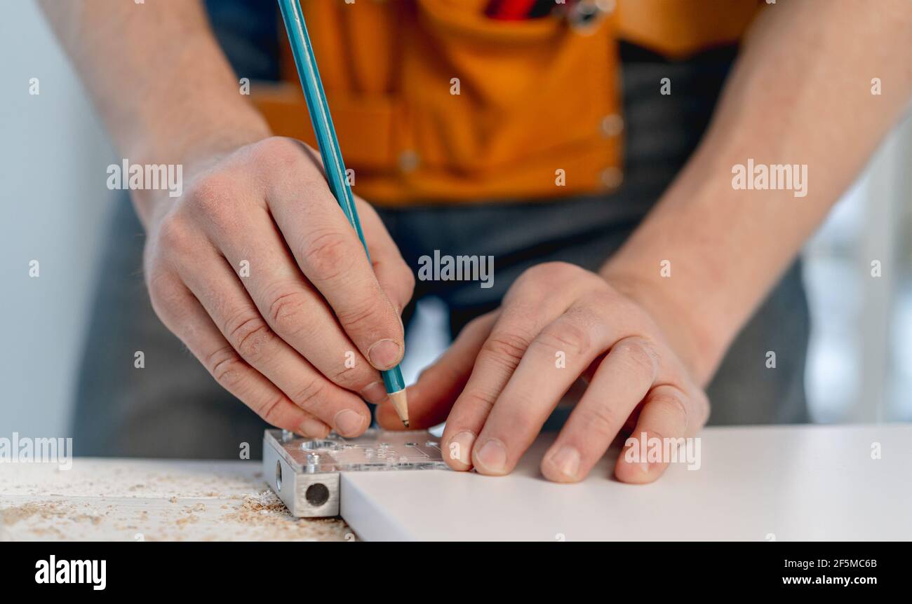 Man working during process of furniture manufacturing Stock Photo - Alamy