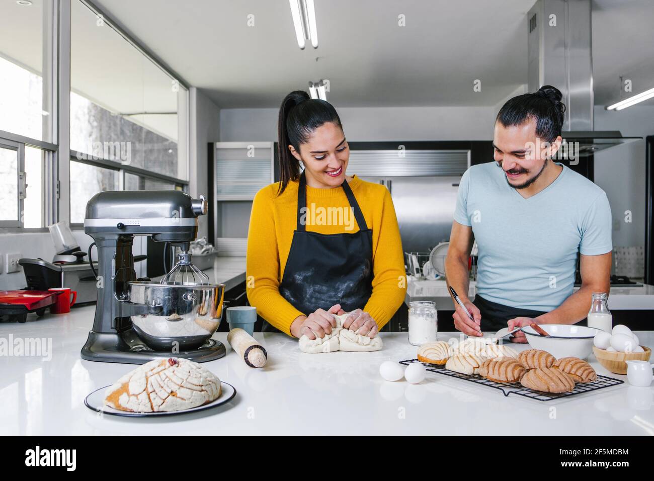 latin couple bakers preparing dough for baking mexican bread called ...