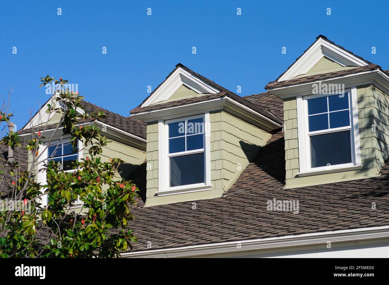 Windows in room above roofline on building structure Stock Photo - Alamy