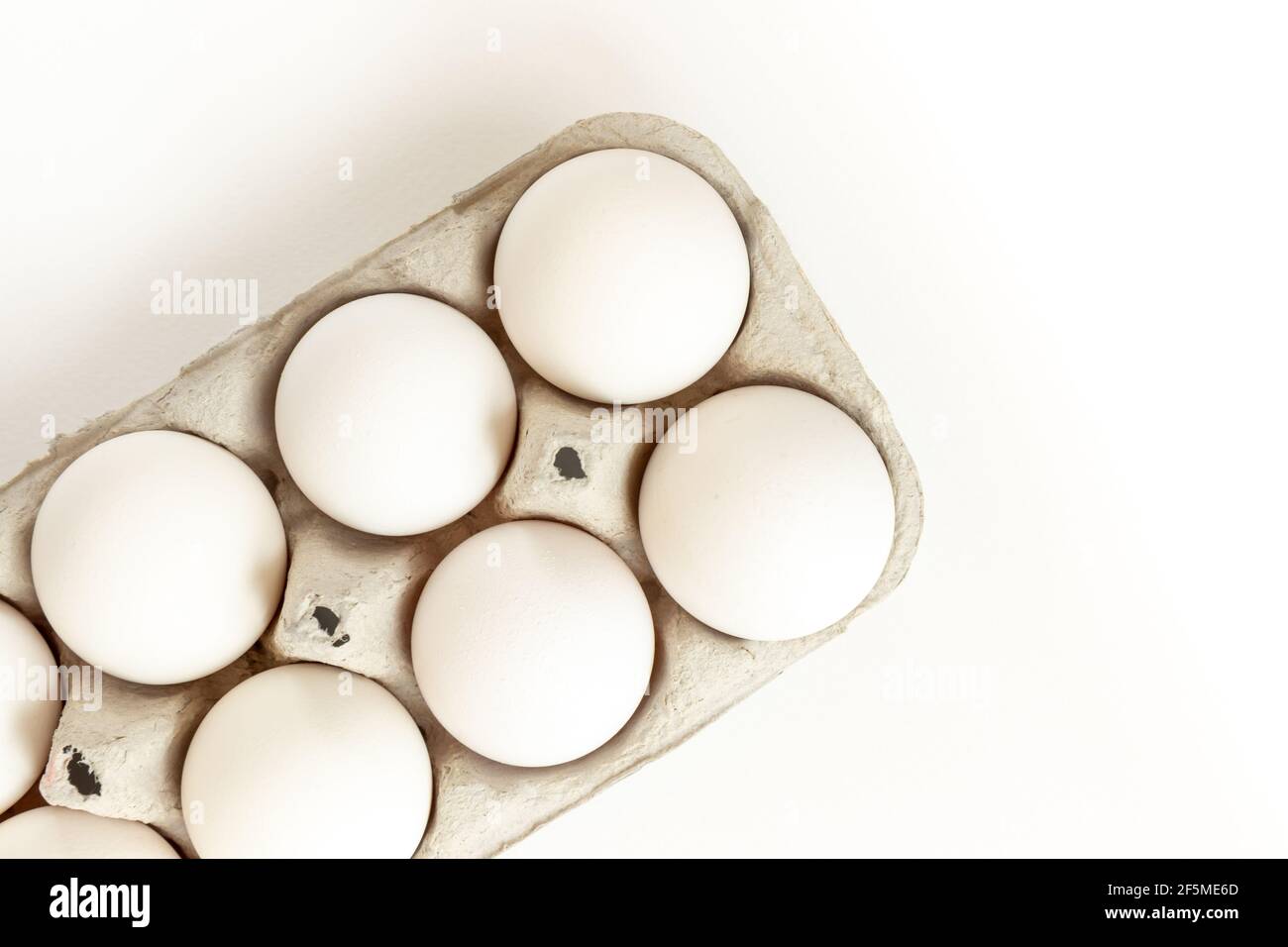 White chicken eggs in box. Cardboard egg box with chicken eggs on white ...