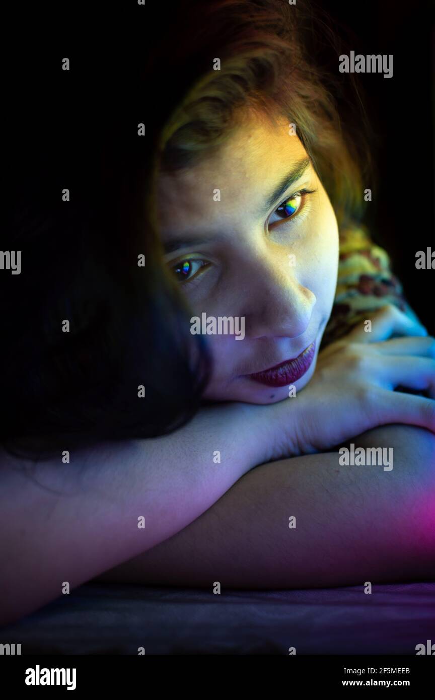 Girl looking at direction with colorful lights on the face Stock Photo ...