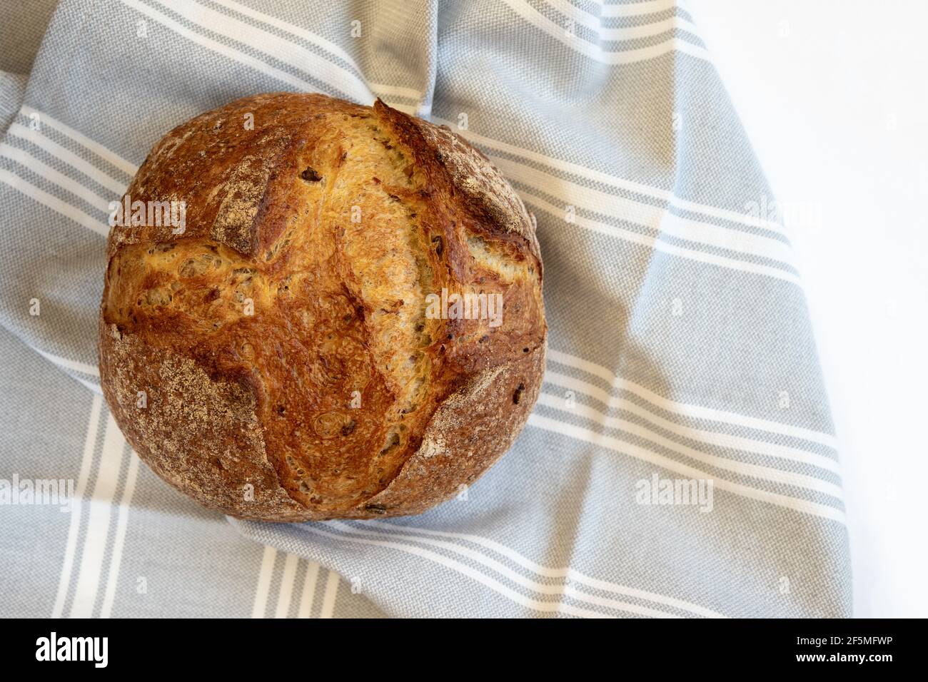 Homemade bread. Freshly baked round loaf of sourdough bread with linen ...