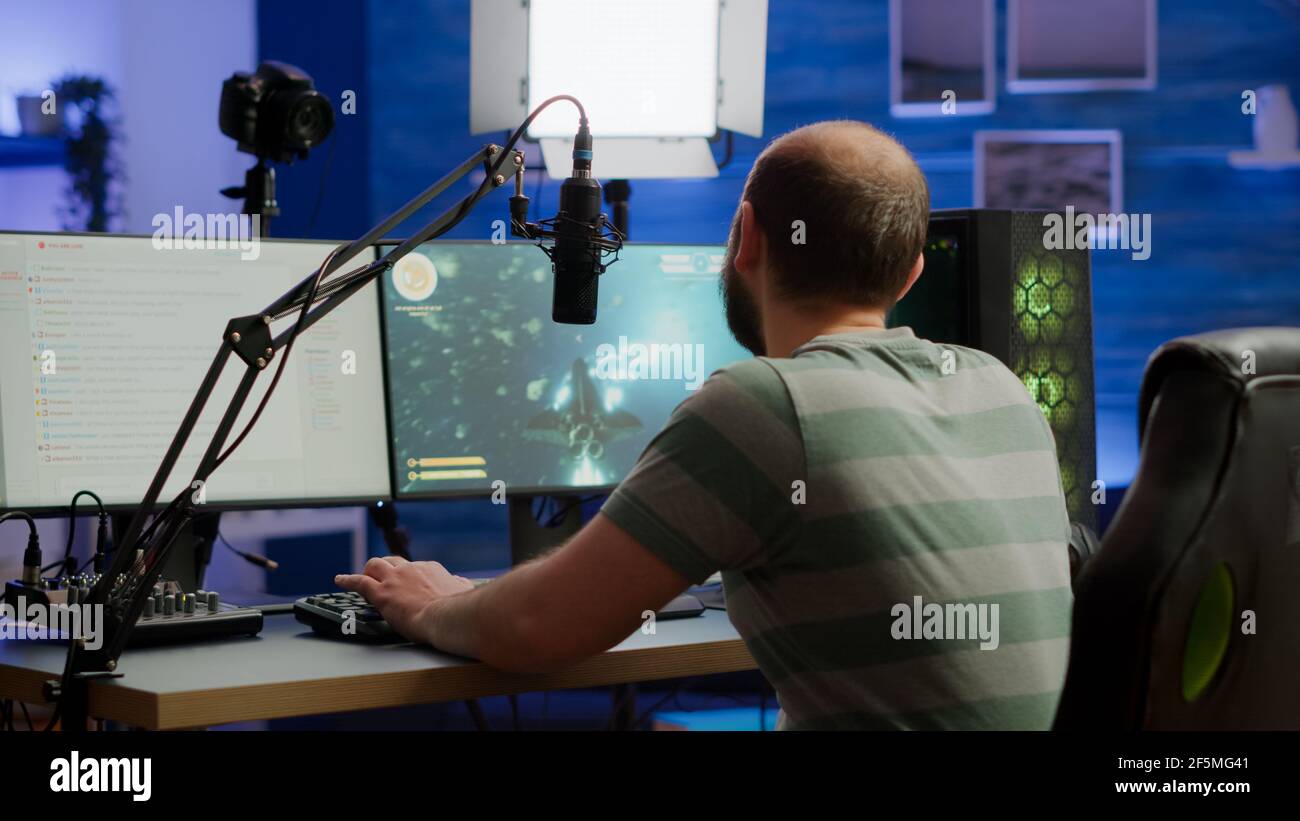 Streamer cyber performing space shooter video game on RGB powerful ...