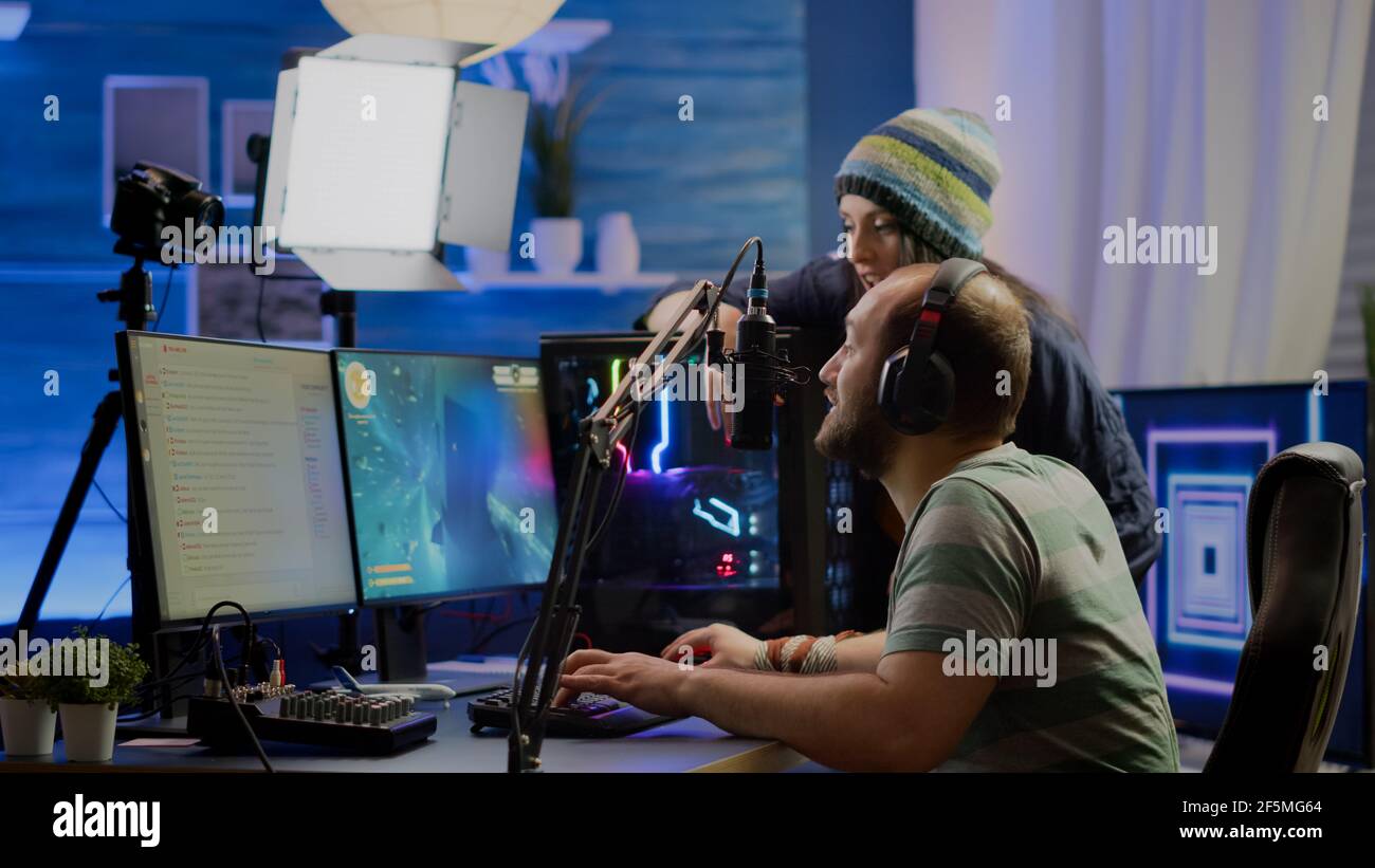 Excited players couple winning online videogames competition using ...