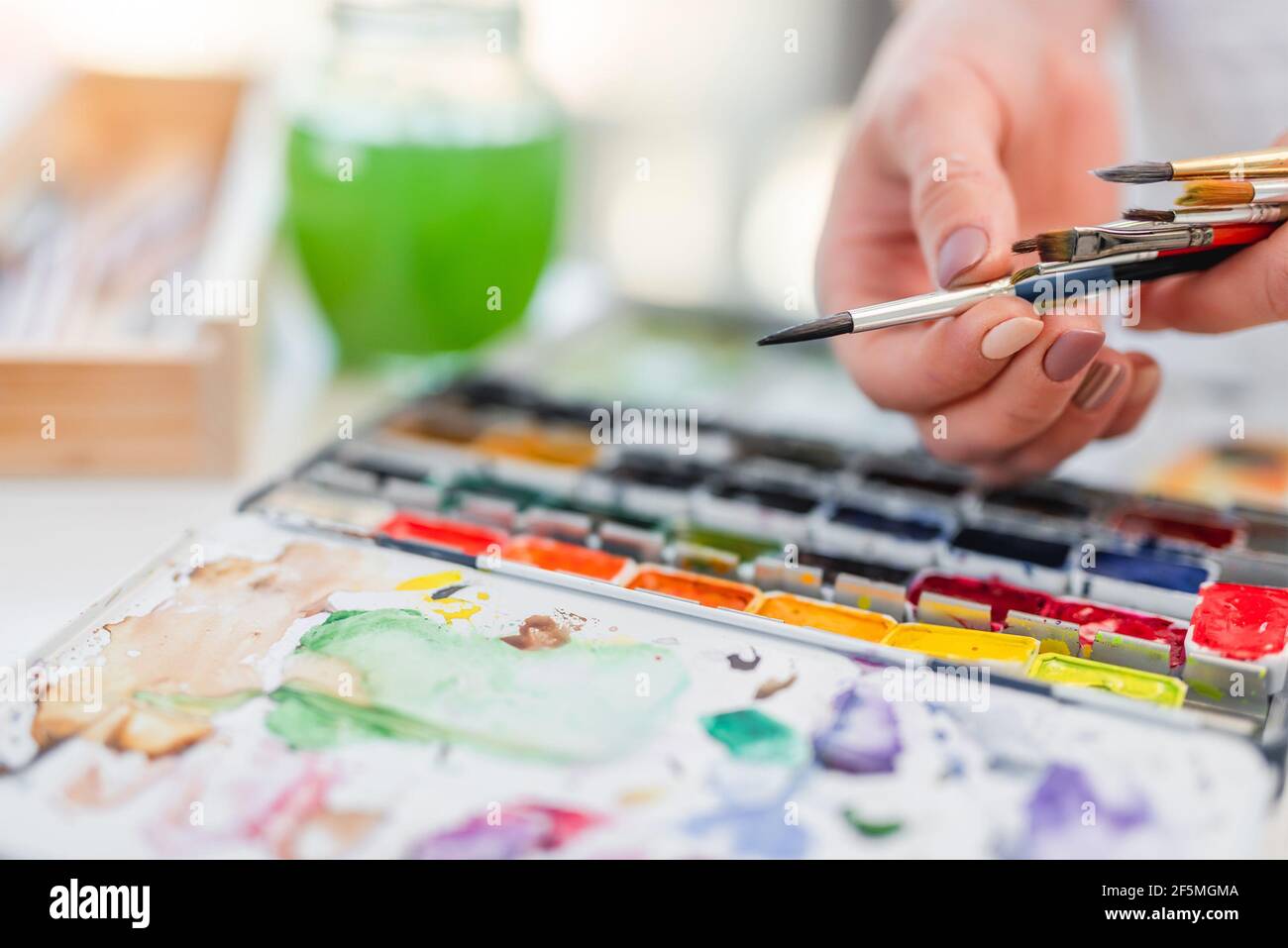 Woman holding brushes paint hi-res stock photography and images - Alamy