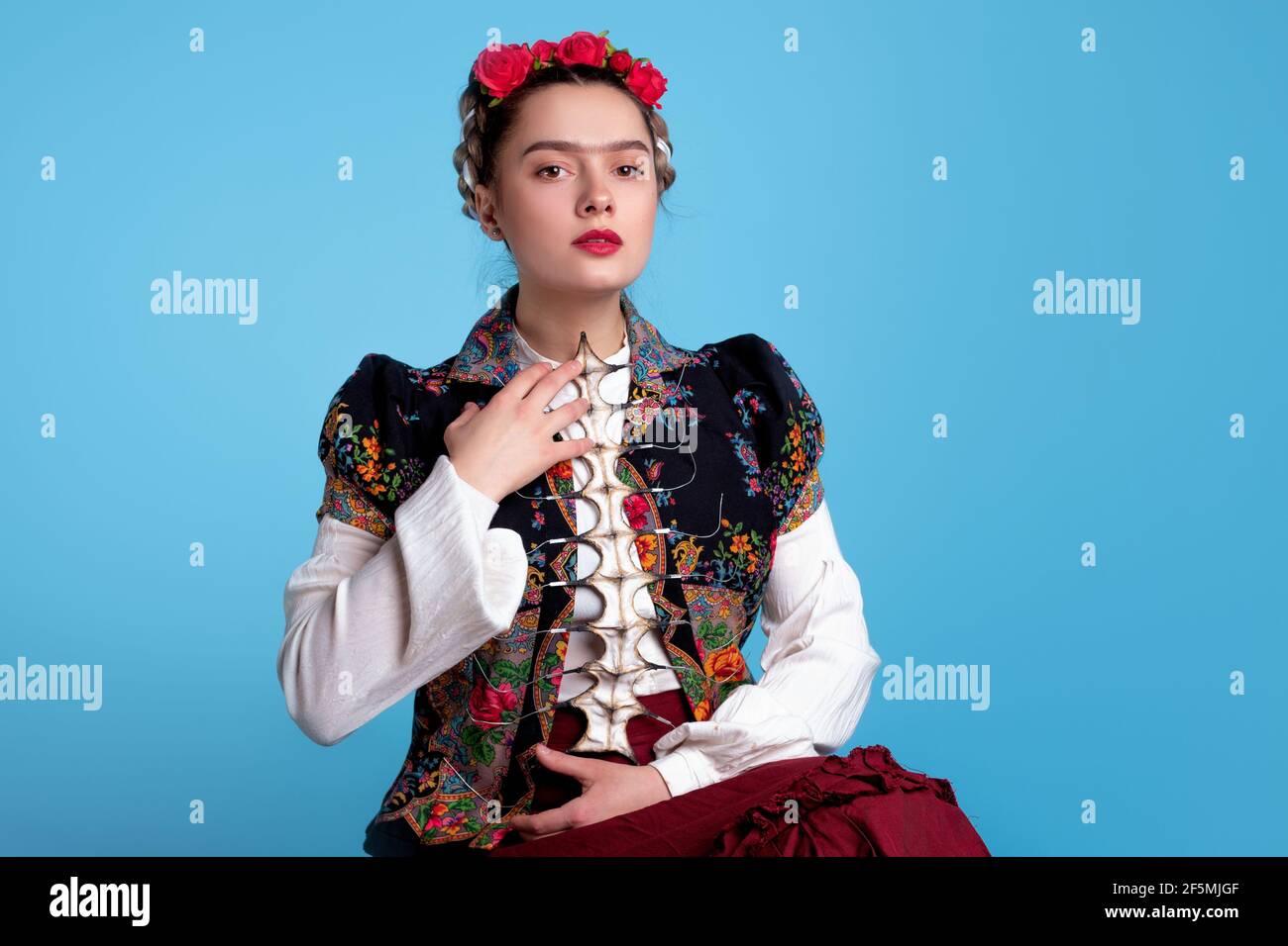 Young woman in the image of the Mexican artist Frida holds its symbolic ...