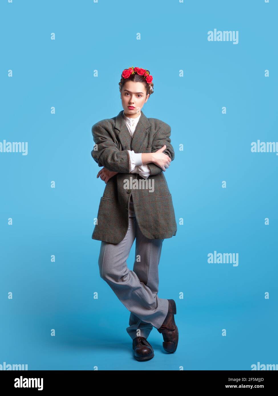 A young woman in a men's suit, gender neutral style. artist Frida Kahlo ...