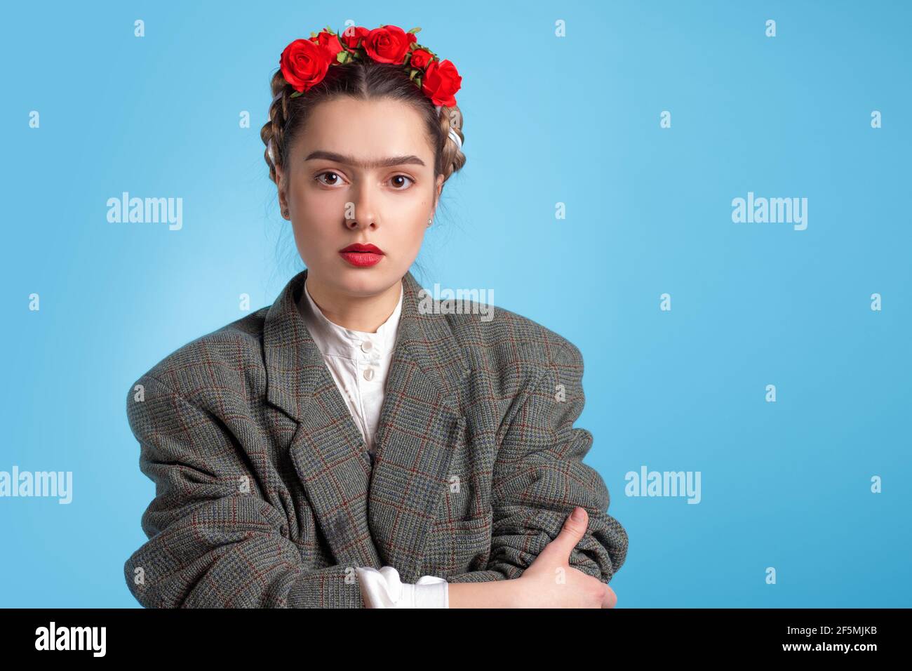 Young woman in the image of the Mexican artist Frida in a man's suit ...