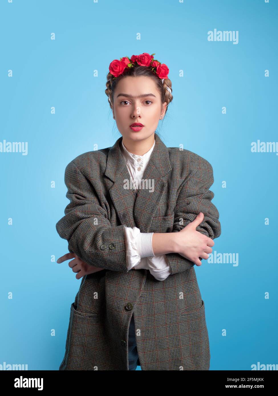 Young woman in the image of the Mexican artist Frida in a man's suit ...