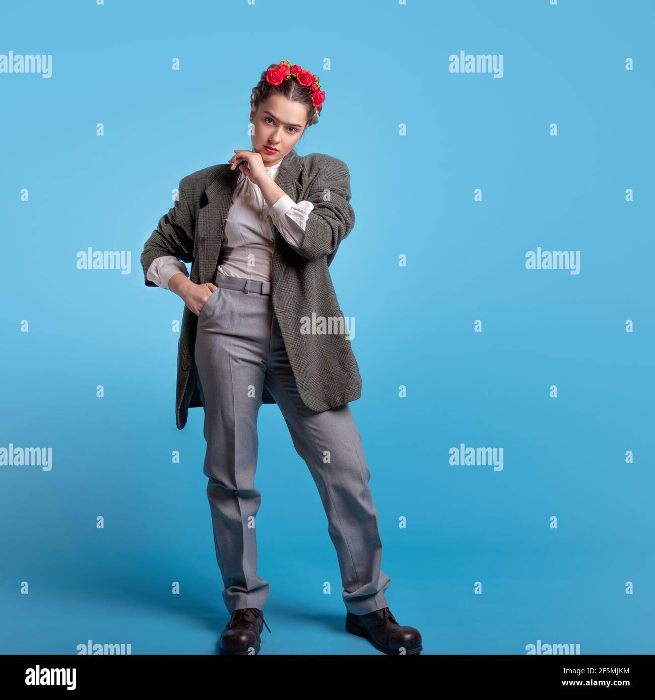 A young woman in a men's suit, gender neutral style. artist Frida Kahlo ...