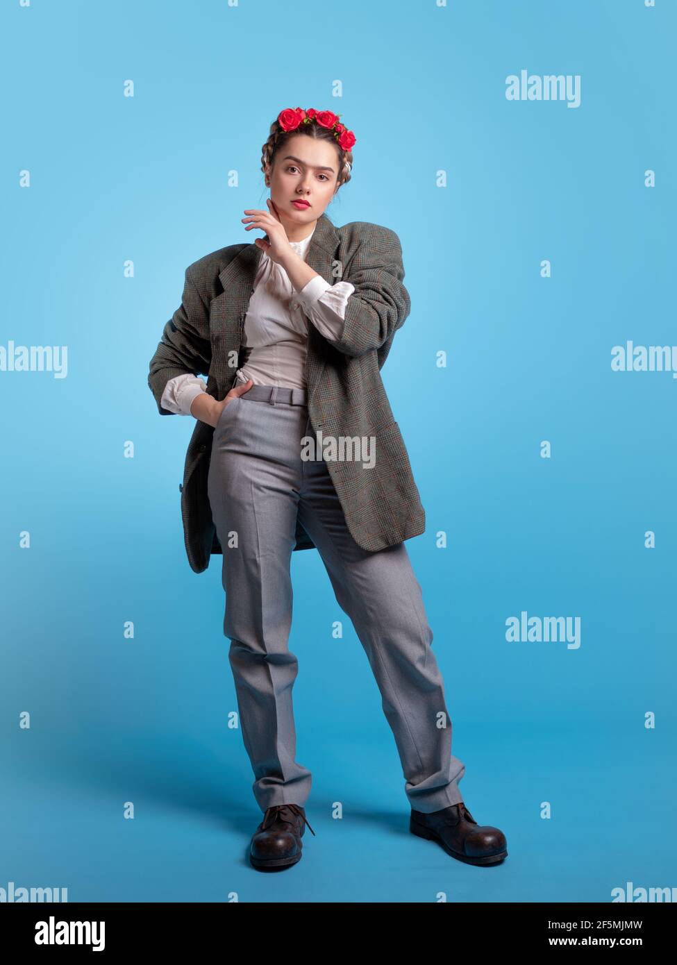 Young woman in the image of the Mexican artist Frida in a man's suit ...