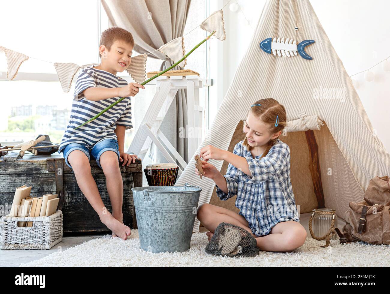 Children catching fish with rod Stock Photo - Alamy