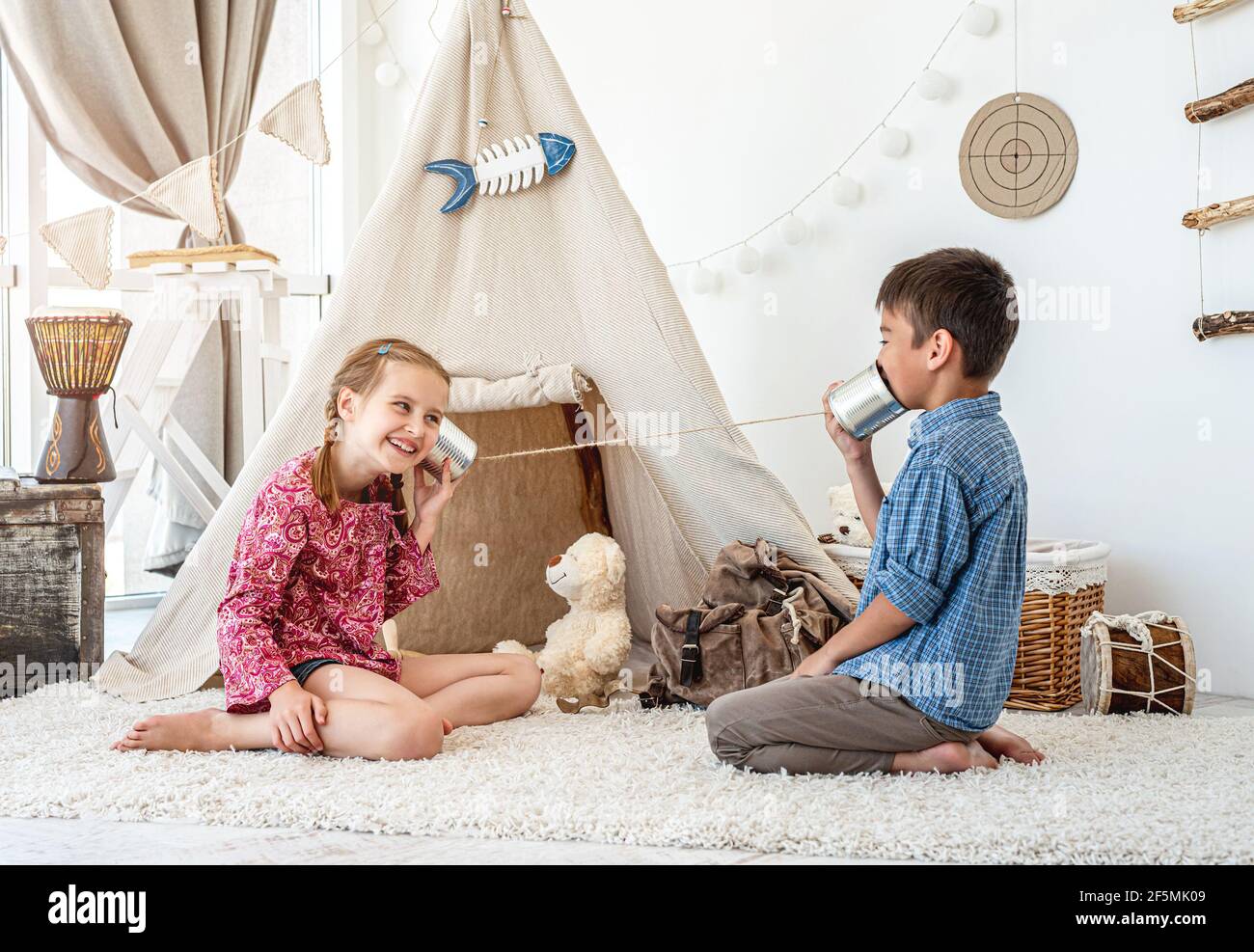 Kids playing with selfmade telephone Stock Photo - Alamy