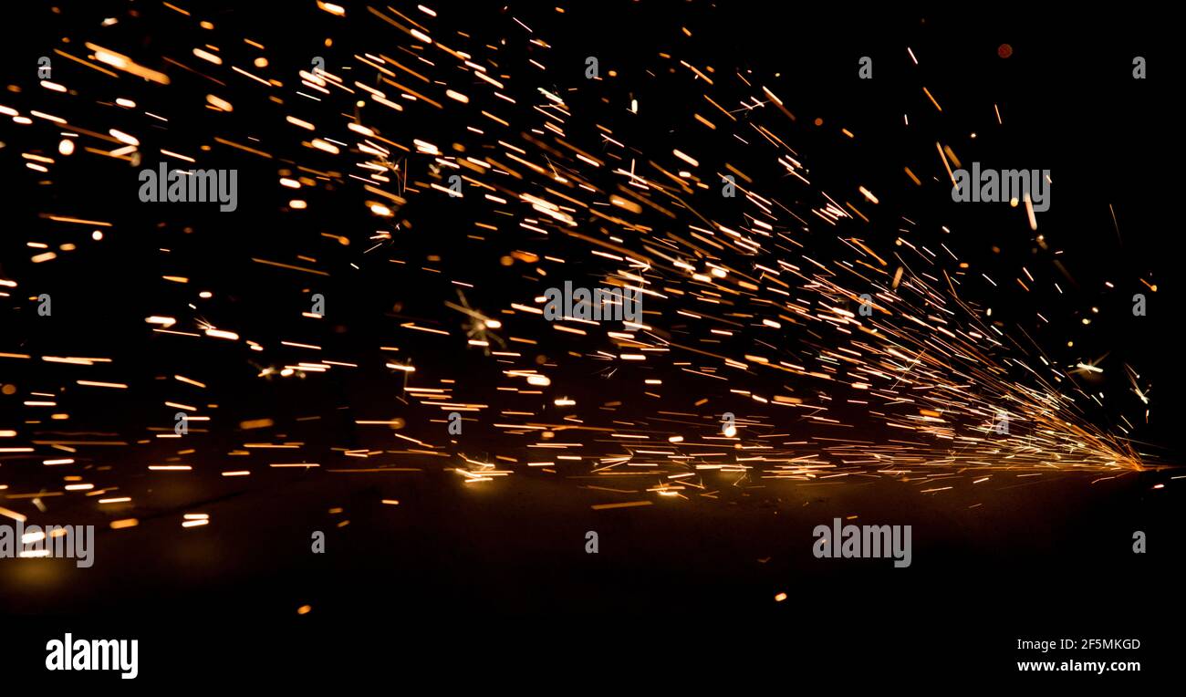 bright sparks of metal against dark background Stock Photo - Alamy